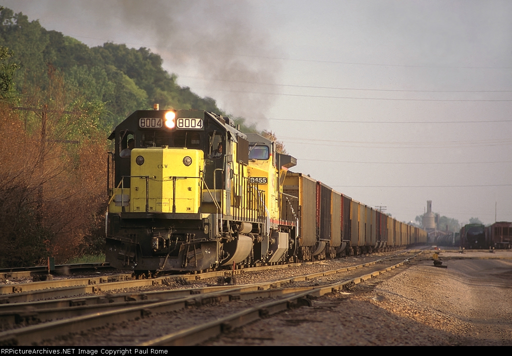 C&NW 8004, EMD SD60, notches out working eastbound coal loads passing the C&NW yard